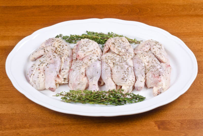 Raw Cornish Game Hen on a White Plate Stock Image - Image of pepper ...