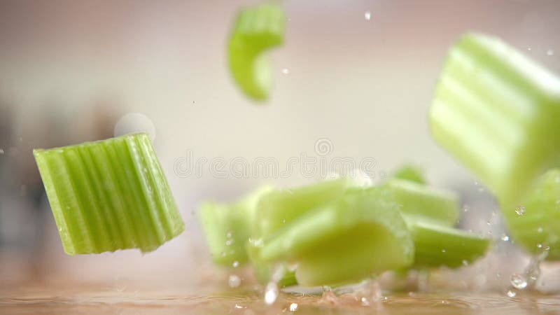 Raw Cut Celery Falling Onto the Wooden Cutting Board Bouncing and ...