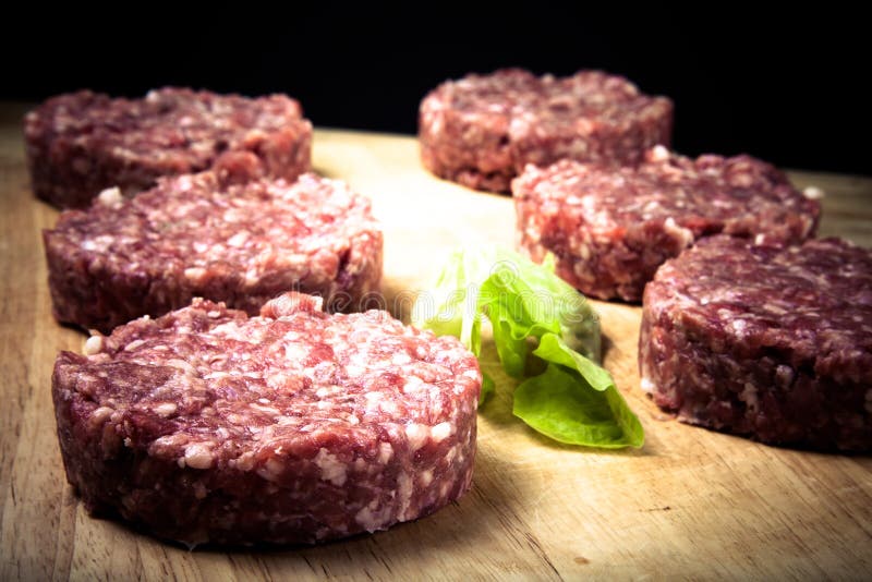 Raw Cutlet of Minced Meat on a Wooden Cutting Board. Toned Stock Image ...
