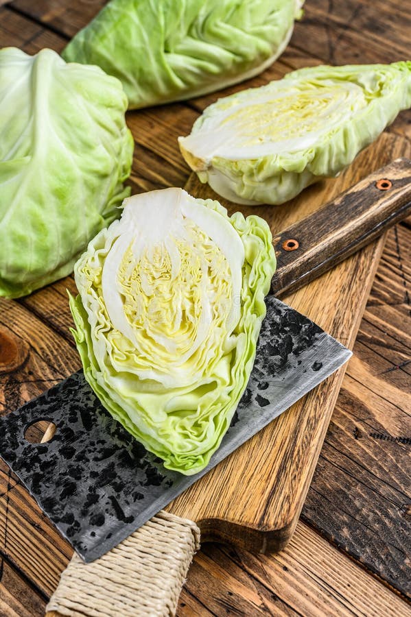 Raw Cutting Pointed White Cabbage Head on a Cutting Board. Wooden ...