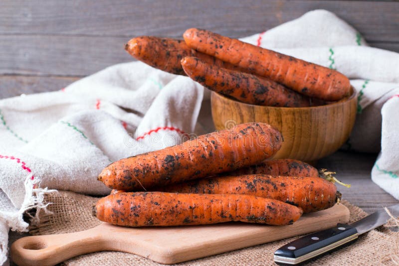 Raw Dirty Carrots on a Wooden Board Stock Photo - Image of garden ...