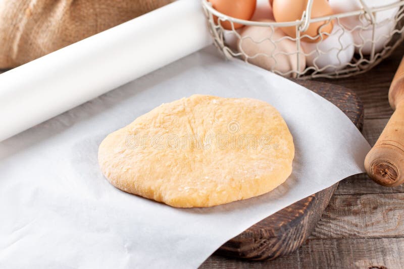 Raw Dough on a Cutting Board on a Rustic Wooden Table. Frozen Dough ...