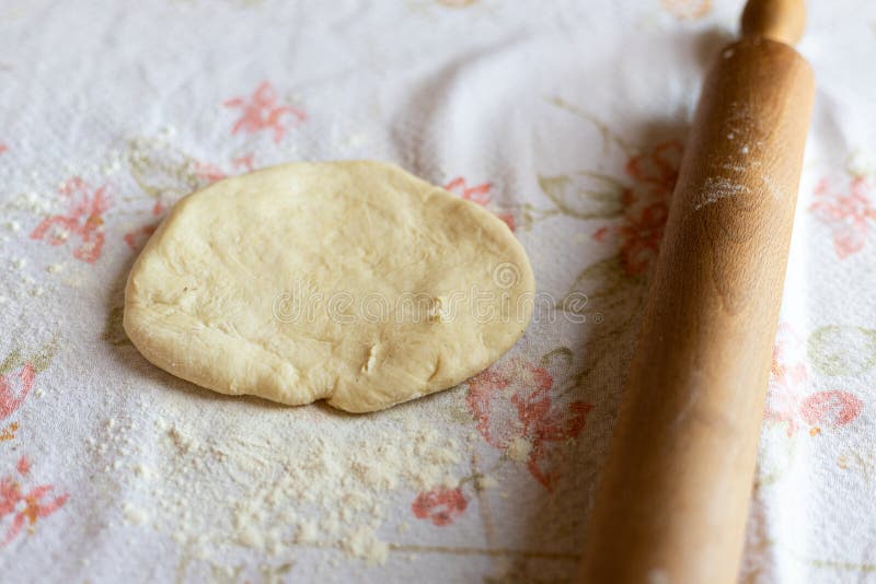 Raw Dough Resting on the Table with Wooden Rolling Pin beside Stock ... Raw Dough Resting on the Table with Wooden Rolling Pin beside Stock ...