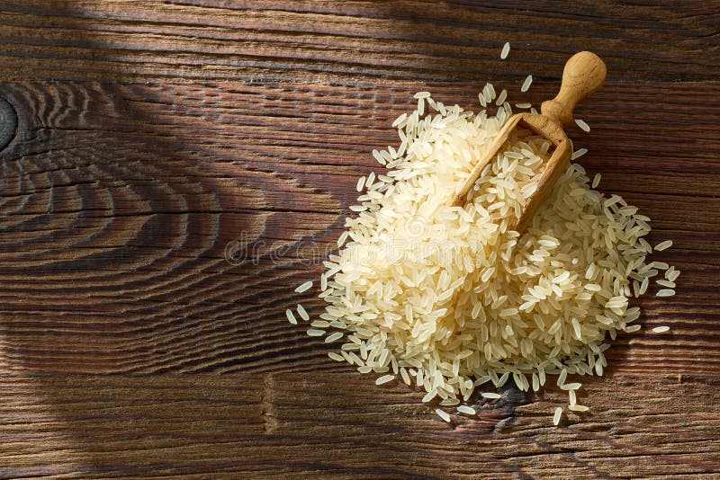 Raw Dried Rice on Wooden Kitchen Table Stock Image - Image of table ...