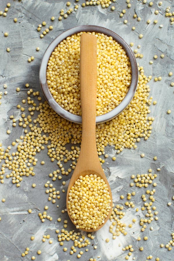 Raw Dry Hulled Millet in a Bowl with a Spoon Stock Photo - Image of ...