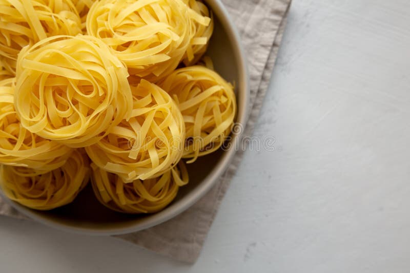 Raw Dry Tagliatelle Pasta in a Bowl, Top View. Flat Lay, Overhead, from ...