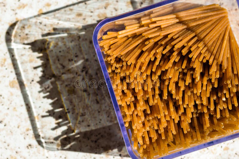 Raw Durum Spaghetti Inside Plastic Storage Container in Home Kitchen ...