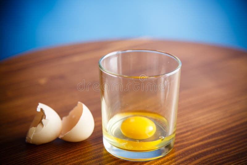 Raw egg in a glass beaker stock image. Image of chicken - 111253003