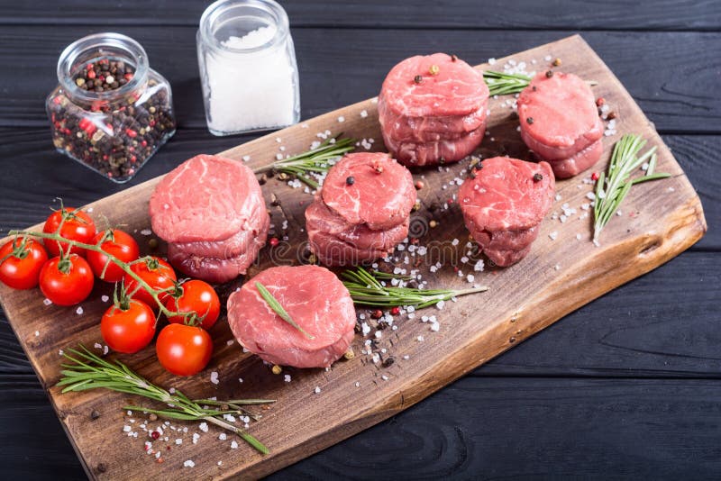 Raw filet mignon stock photo. Image of board, herb, black - 145478446