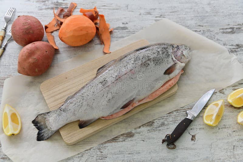 Raw Fish for Cooking with Vegetables on the Kitchen Table. Stock Photo ...