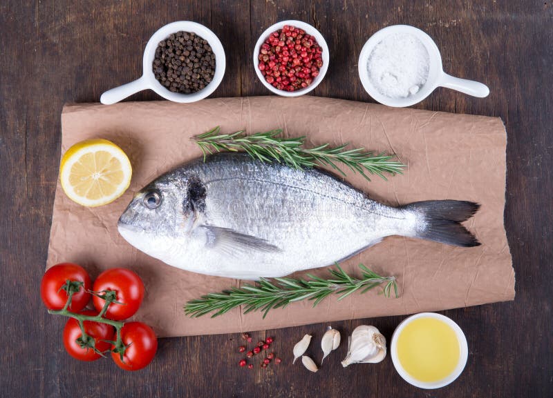 Raw Fish Dorado Cooking and Ingredients. Dorado, Lemon, Tomato, Herbs ... Raw Fish Dorado Cooking and Ingredients. Dorado, Lemon, Tomato, Herbs ...