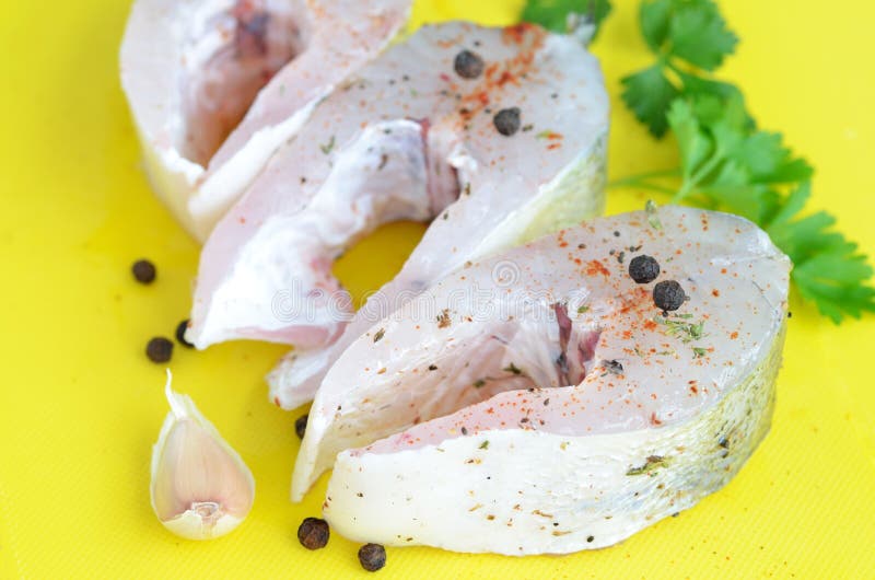 Raw Fish Fillet with Garlic and Spices Stock Photo - Image of peppers ...