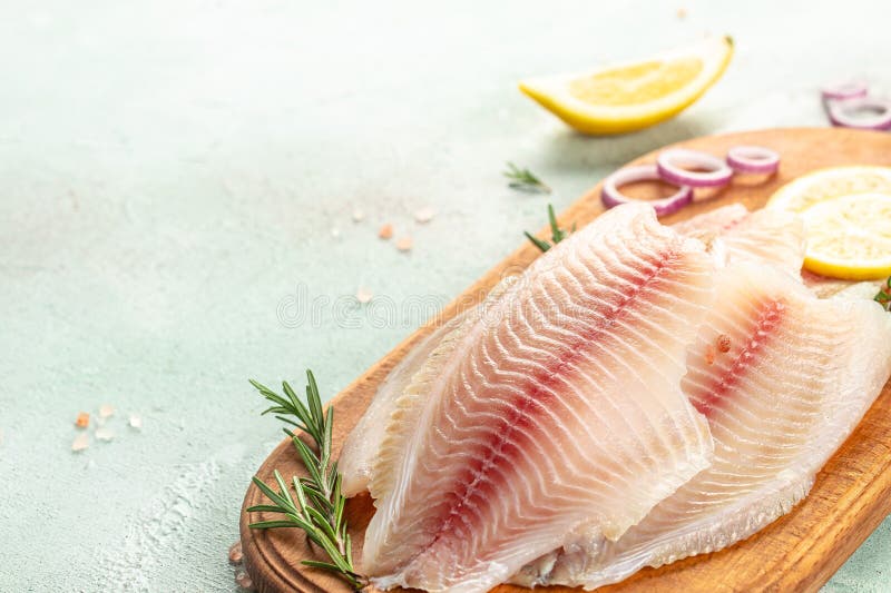 Raw Fish Fillet White Tilapia on a Light Background. Top View Stock ...