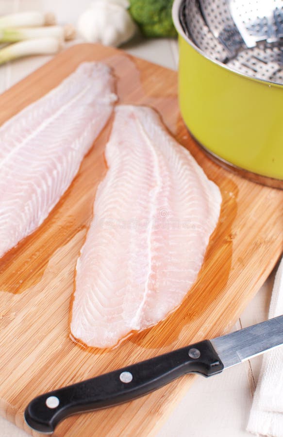 Raw Fish Fillets on Cutting Board Stock Image - Image of hake, seafood ...