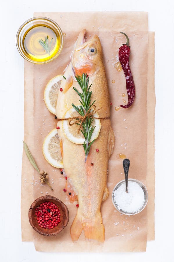 Raw Fish Golden Trout with Herbs, Lemon and Spices Stock Image - Image ...
