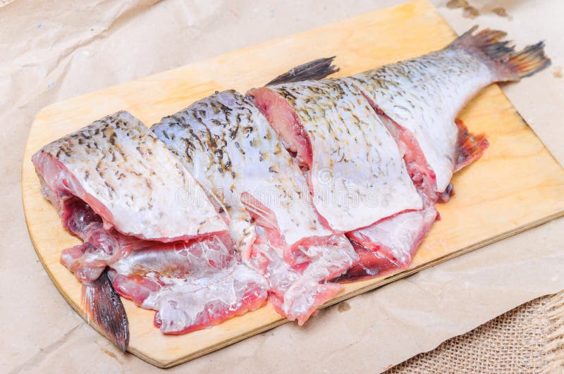 Raw Fish Ide Cut into Pieces for Cooking on a Chopping Board Stock ...