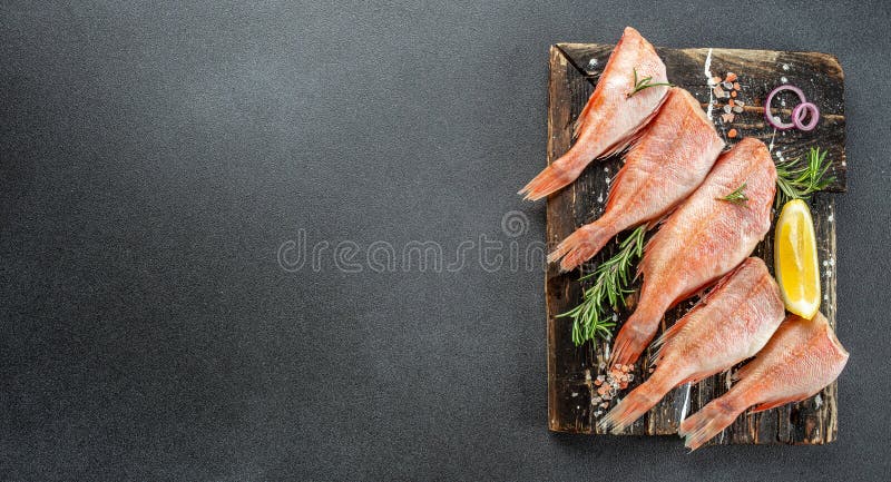 Raw Fish Perch with Lemon, Rosemary, Salt on a Dark Background. Long ...