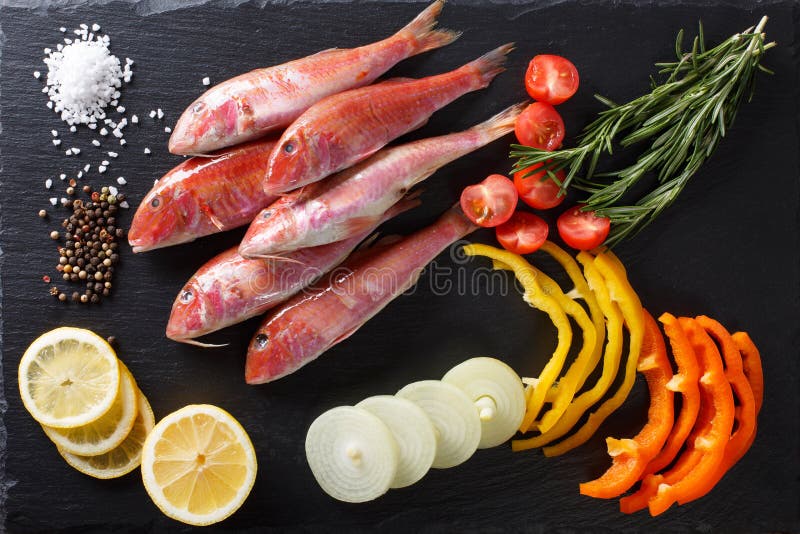 Raw Fish Red Mullet with Vegetables and Lemon on the Table. Horizontal ...