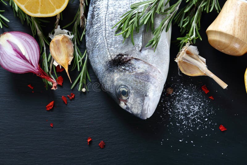 Raw fish on the slate stock image. Image of gilthead - 48802115
