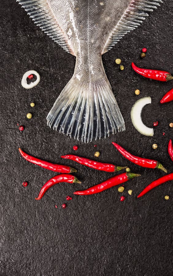 Raw Fish Tail with Spices on Dark Stone Background, Top View Stock ...