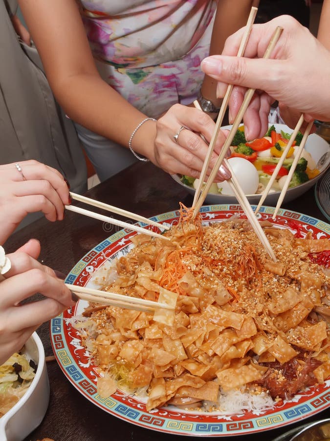 Raw Fish - Yusheng / Lo Hei Stock Photo - Image of chopsticks, hands ...