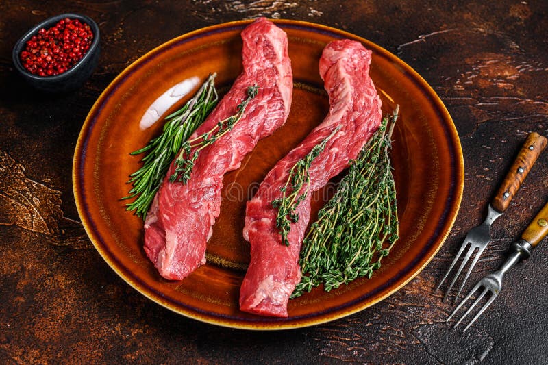 Raw Flank Beef Meat Steak on a Plate. Dark Background Stock Photo ...