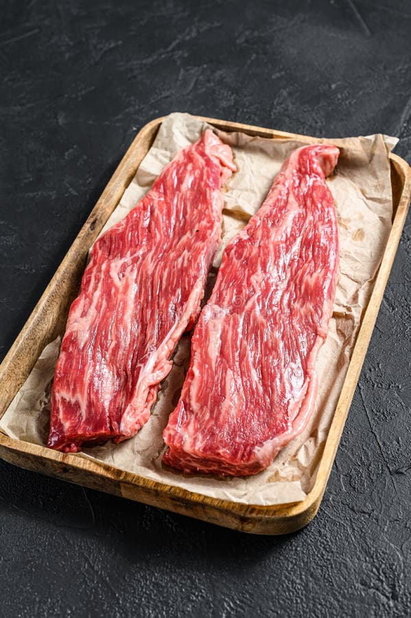 Raw Flank Steak. Fillet of Marbled Beef. Black Background Stock Photo ...