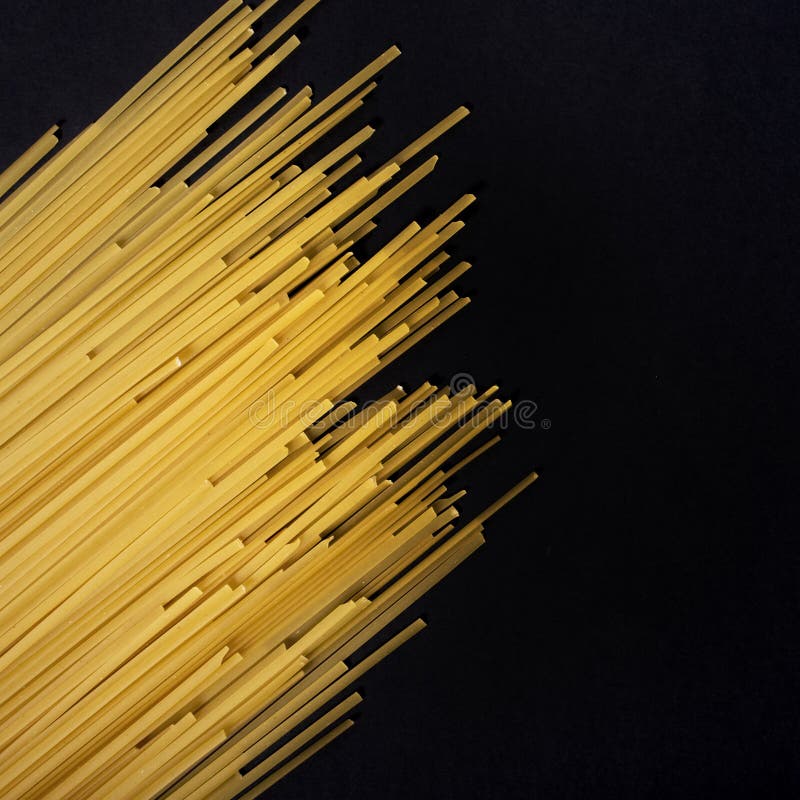 Raw Flat Spaghetti on Black Background Stock Photo - Image of ...