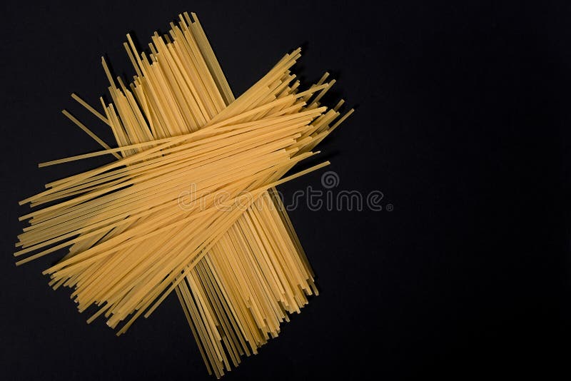 Raw Flat Spaghetti on Black Background Stock Photo - Image of ...