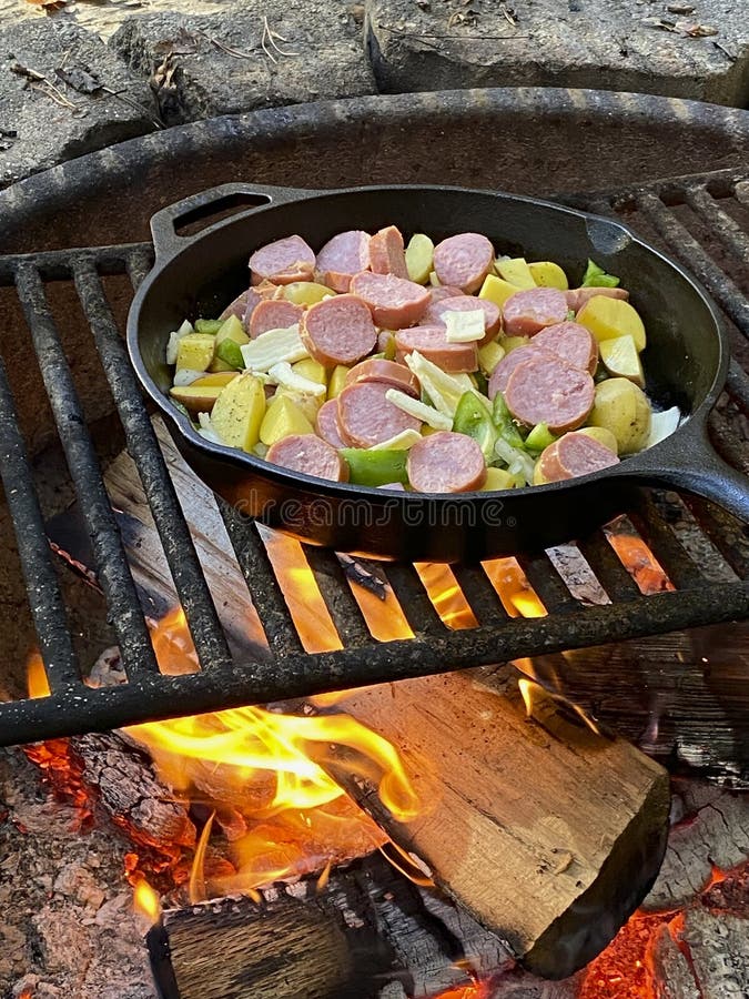 Raw Food Cooking in Cast Iron Skillet Over Campfire Stock Photo - Image ...