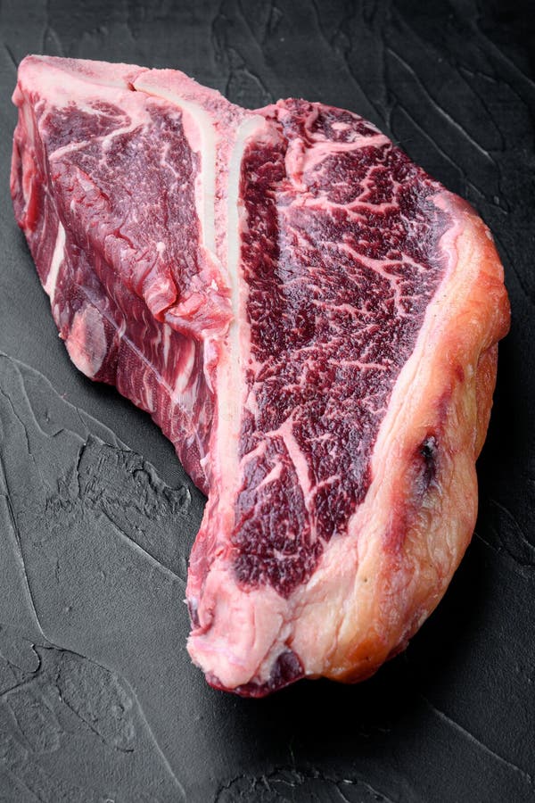 Raw Fresh Dry Aged Beef T-bone Steak, on Black Stone Background Stock ...
