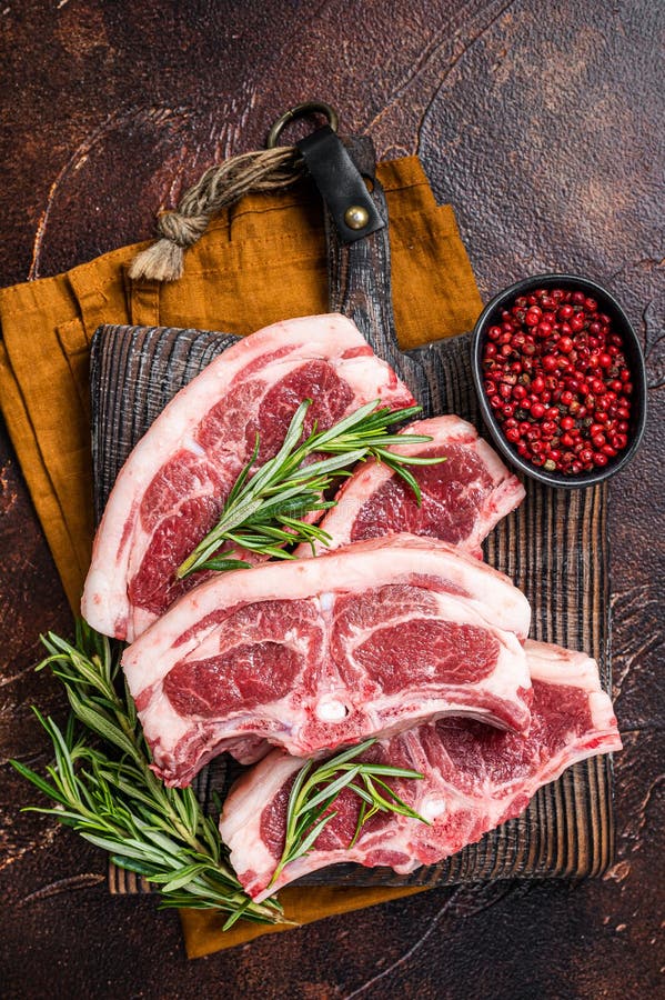 Raw Fresh Saddle of Lamb Mutton with Herbs and Spices on Butcher Board ...