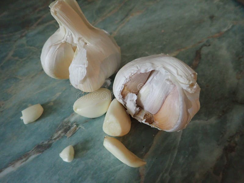 Raw garlic on a table stock image. Image of ingredient - 264502805