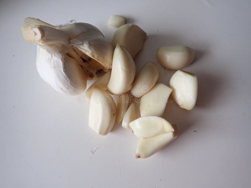 Raw garlic on a table stock photo. Image of cooking - 264502968