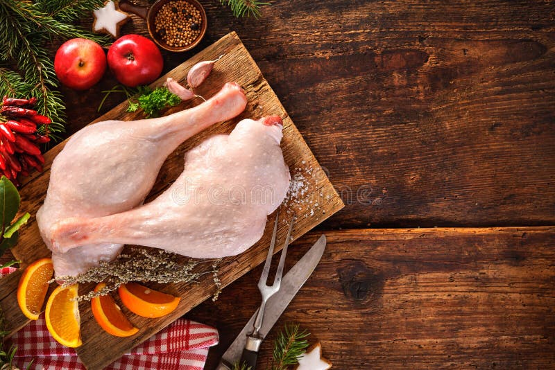 Raw Goose Legs with Herbs on Cutting Board Stock Photo - Image of ...