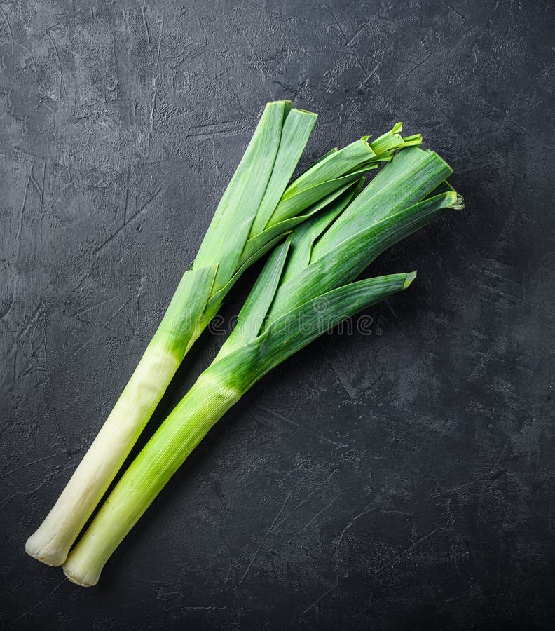 Raw Green Organic Leeks on Black Textured Background, Top View Stock ...