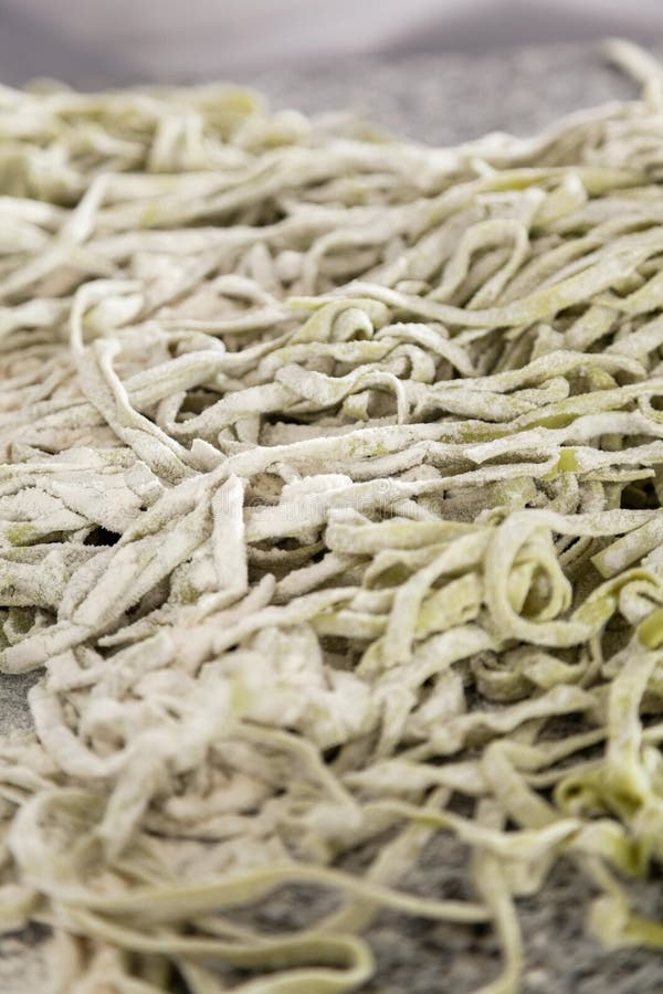 Raw Green Spaghetti Pasta on Counter Stock Image - Image of processing ...