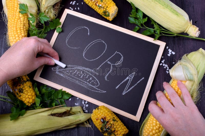 Raw and Grilled Maize Cobs are Framing the Blackboard with the Word ...
