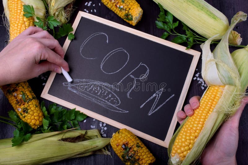 Raw and Grilled Maize Cobs are Framing the Blackboard with the Word ...