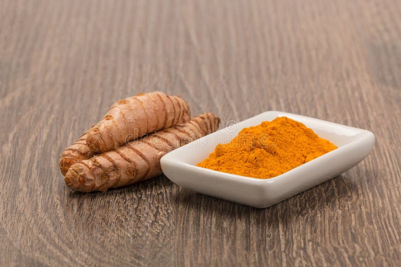 Raw and ground turmeric, stock photo. Image of grocery - 111112612