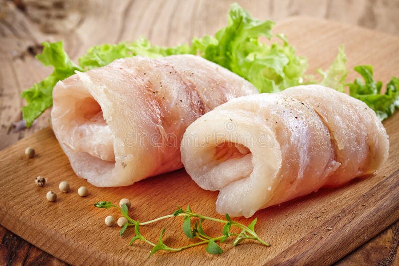 Raw hake fish fillet rolls stock photo. Image of lettuce - 42349502