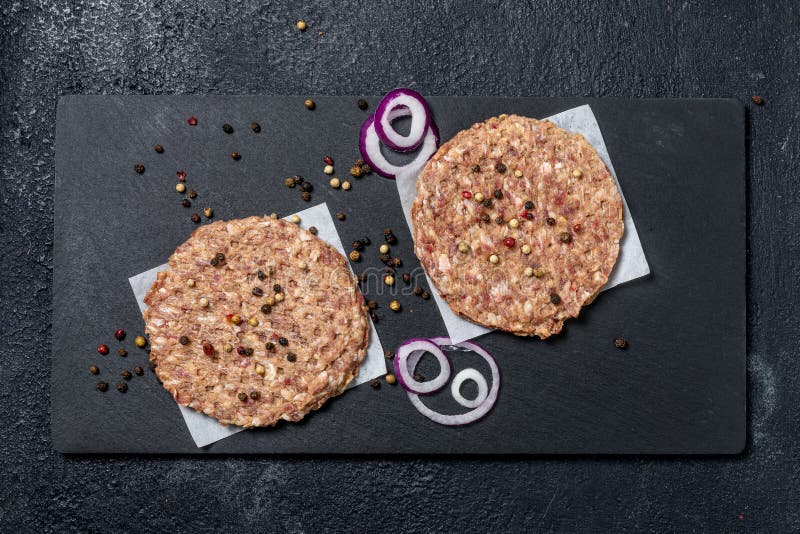 Raw Hamburger Cutlets on Black Stone. Stock Photo - Image of gourmet ...