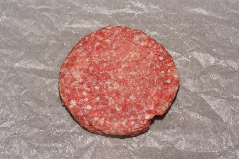 Raw Hamburger Patty Isolated on White Parchment Paper. Stock Image ...