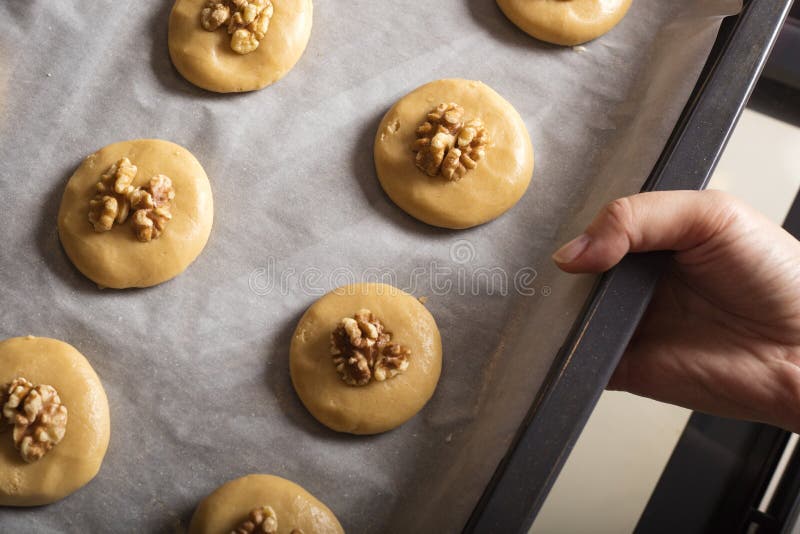Raw Honey Biscuits with Walnuts on a Baking Sheet with Parchment Paper ...