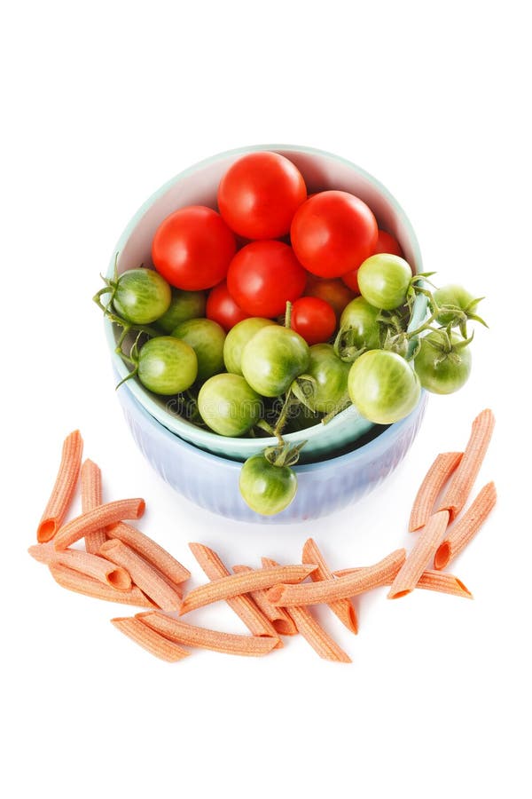 Raw Italian Pasta with Red and Green Tomatoes on White Background Stock ...
