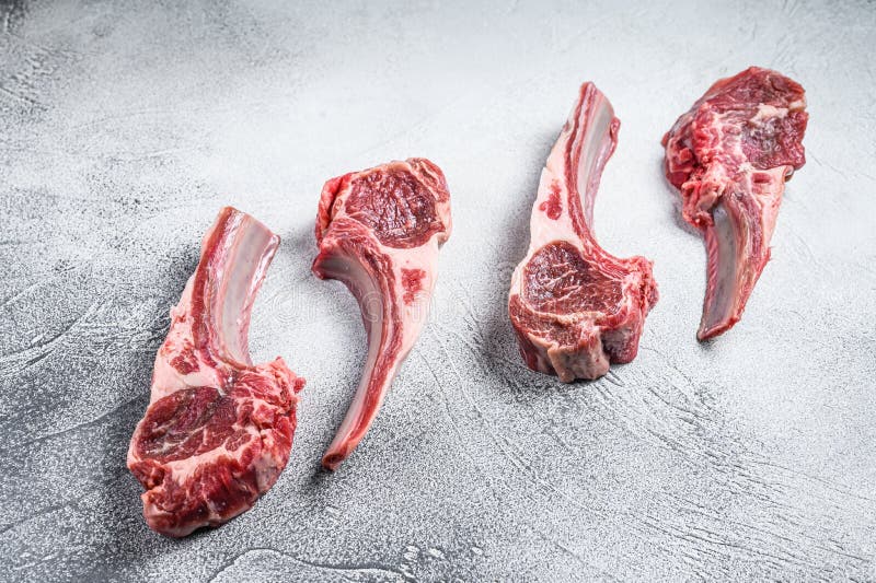 Raw Lamb Meat Chops on a Butcher Table. White Background Stock Photo ...