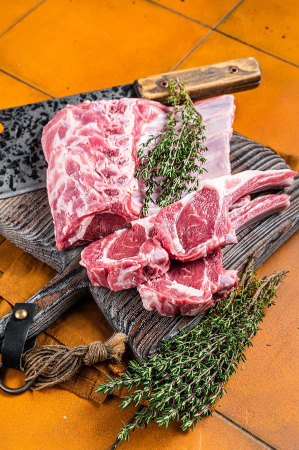 Raw Lamb Meat Chops Cutlets on Butcher Cutting Board. Orange Background ...