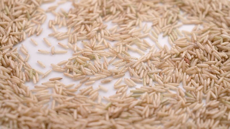 Raw Long Basmati Rice Falling on a White Ceramic Surface Stock Footage ...