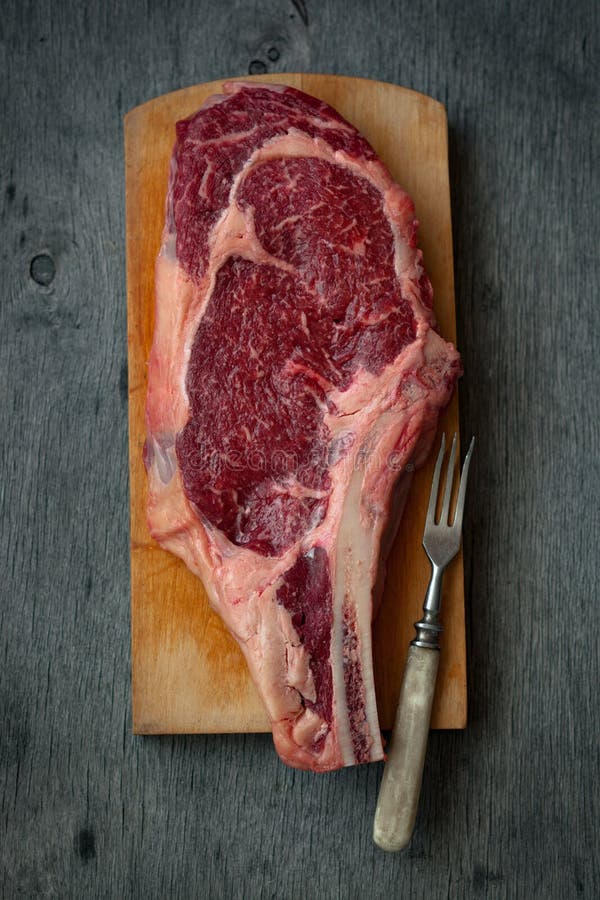 Two Raw Marbled Beef Steaks are Grilled in the Dark in the Evening ...