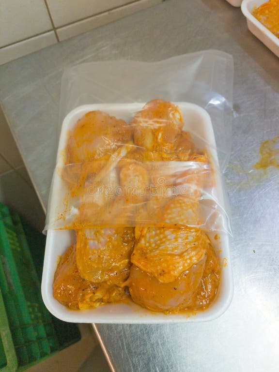 Raw Marinated Chicken Drumsticks in Tray - in Process of Packaging ...